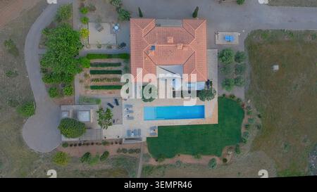 Aerial view of luxury terracotta villa rooftops above Mediterranean Sea ...