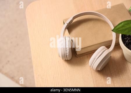 White earbuds rest on wooden surface. Simple design, clean background ...
