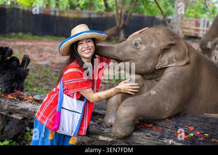 Elephant, woman, calf, straw hat, forest, pink shirt, gentle ...