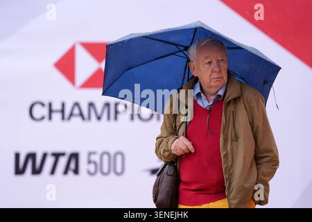A spectator arrives during day four of the HSBC Championships at The ...