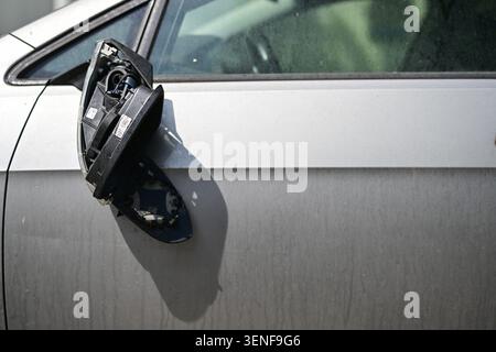08 June 2026, Berlin: A worn wing mirror is hanging on a car. Photo ...