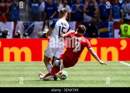 Amar Memic of Bosnia and Herzegovina is tackled by Alistair Johnston of ...