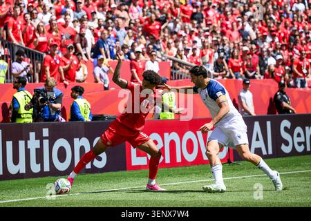 Tajon Buchanan of Canada competes for the ball with Amar Memic of ...