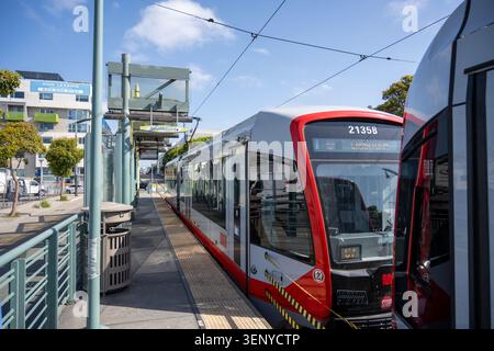 MUNI train in a streetside station on sunny day, San Francisco ...