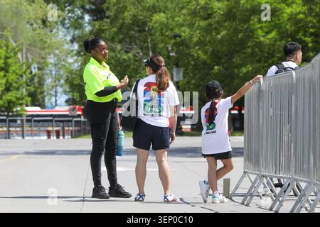 Toronto, Canada. 12 June, 2026. A presumed mother and daughter wait to ...