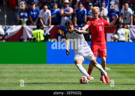 Amar Dedic of Bosnia and Herzegovina competes for the ball with Liam ...
