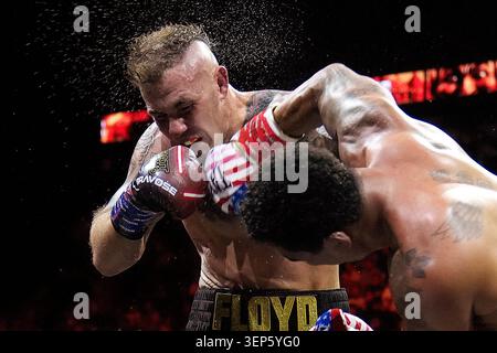 Eddie Hall (right) lands a punch on Tommy Fury during their Heavyweight ...