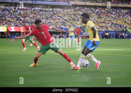 Vinicius Junior of Brazil competes for the ball with Carlens Arcus of ...