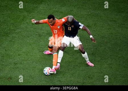 Guela Doue of Cote d'Ivoire competes for the ball with Enner Valencia ...
