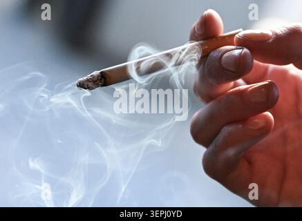 11 June 2026, Berlin: A woman is holding a smoking cigarette. Photo ...