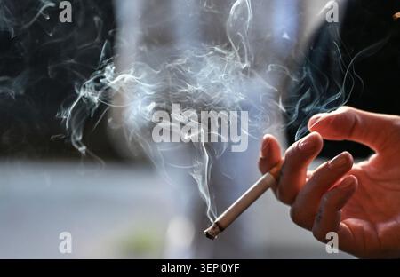 11 June 2026, Berlin: A woman is holding a smoking cigarette. Photo ...