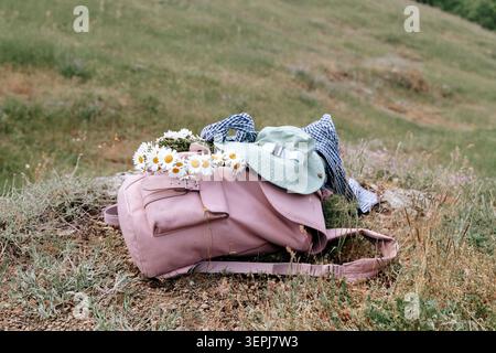 A charming, scenic shot featuring a pastel pink backpack resting on a ...