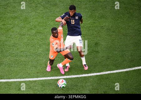 Nicolas Pepe of Cote d'Ivoire competes for the ball with Pedro Vite of ...