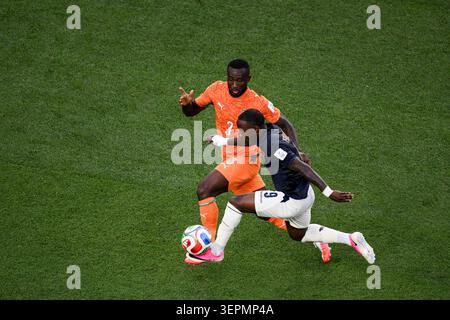 John Yeboah of Ecuador competes for the ball with Ghislain Konan of ...