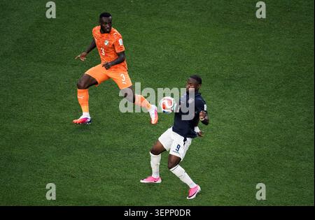 John Yeboah of Ecuador competes for the ball with Ghislain Konan of ...