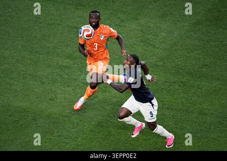 John Yeboah of Ecuador competes for the ball with Ghislain Konan of ...