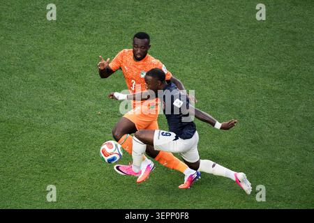 John Yeboah of Ecuador competes for the ball with Ghislain Konan of ...