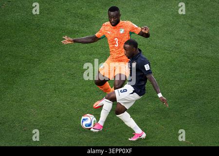 John Yeboah of Ecuador competes for the ball with Ghislain Konan of ...