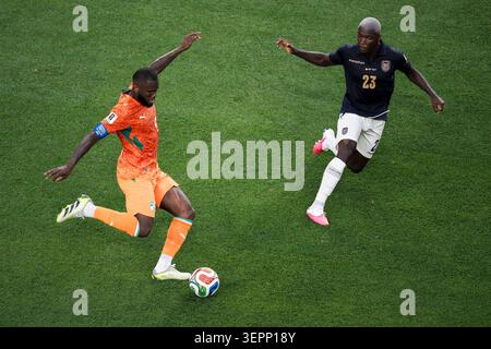 Franck Kessie of Cote d'Ivoire is challenged by Moises Caicedo of ...