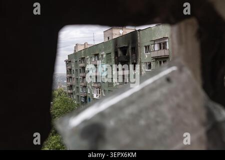Druzhkivka, Ukraine. 15th June, 2026. A woman steps out of her house in ...