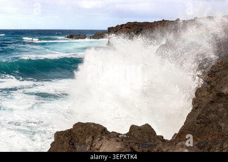 Heavy seas breaking on volcanic rocks at El Golfo on the south west ...