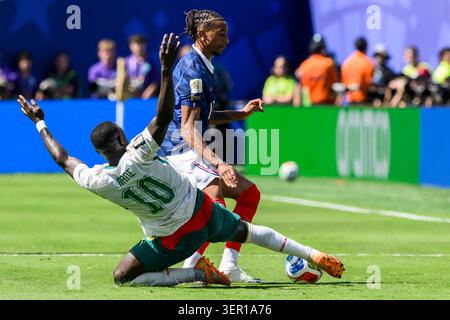 Michael Olise of France competes for the ball with Sadio Mane of ...
