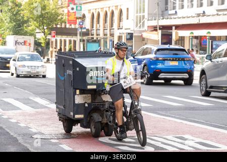 An Amazon delivery worker rides a battery-powered e-cargo bike in ...