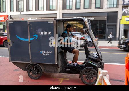 An Amazon delivery worker rides a battery-powered e-cargo bike in ...