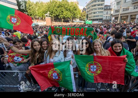 Young Portugal supporters hold flags and a team scarf while gathering ...