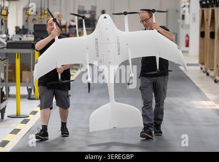 Weiterstadt, Germany. 18th June, 2026. Wingcopter employees carry a ...