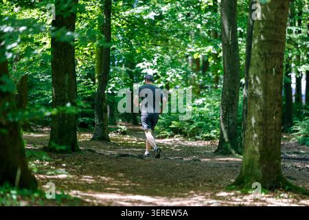 Aachen, Germany. 18th June, 2026. A road cyclist is riding along a ...