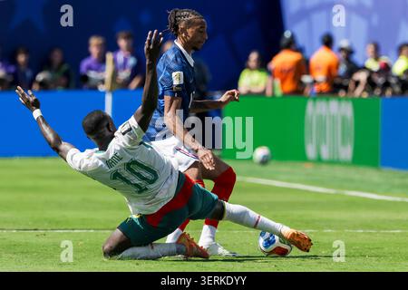 Michael Olise of France competes for the ball with Nicolas Jackson of ...