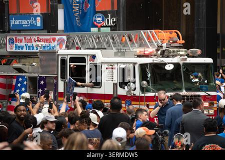 FDNY firefighters wave from their engine during the 2026 NBA ...