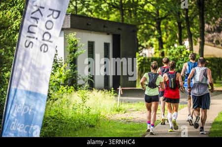 DEN DOLDER - Participants in a marathon at a water station on the route ...