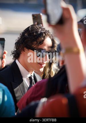 22 June 2026, Berlin: Actor Tom Holland signs an autograph as he ...
