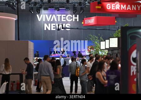 This photograph shows the VivaTech event as visitors walk around in ...