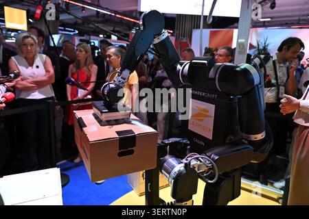This photograph shows the VivaTech event as visitors walk around in ...