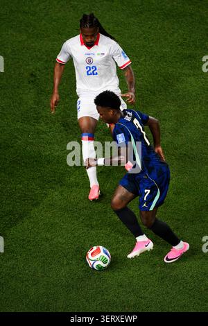 Vinicius Junior of Brazil competes for the ball with Jean-Kevin Duverne ...