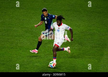 Louicius Deedson of Haiti is challenged by Douglas Santos of Brazil ...