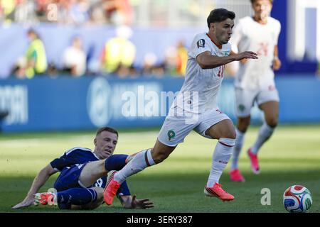 Brahim Diaz (Morocco) and Lewis Ferguson (Scotland) battle for the ball ...