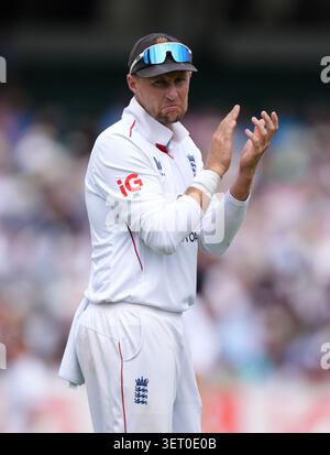 LONDON, ENGLAND - JUNE 20: Joe Root of England (R) raises his bat after ...