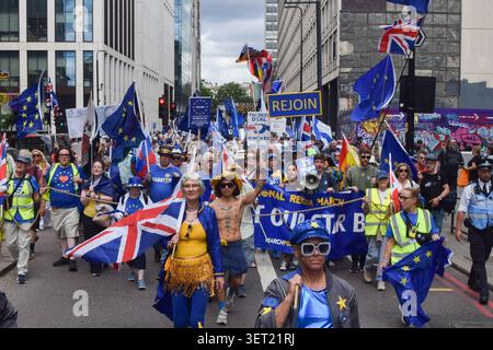 Protesters pass near Waterloo station with EU flags and pro-EU placards ...