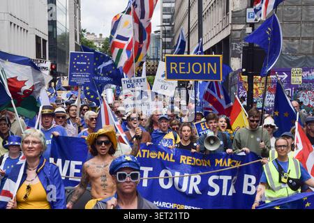 Protesters pass near Waterloo station with EU flags and pro-EU placards ...