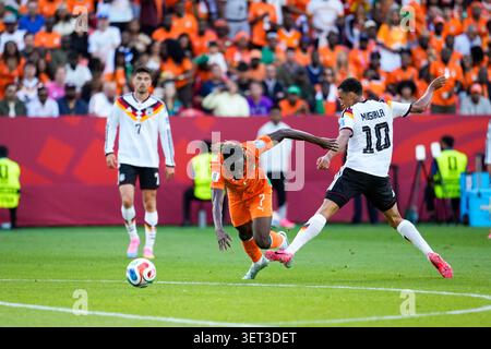 Germany midfielder Jamal Musiala (10) trips Ivory Coast defender Odilon ...