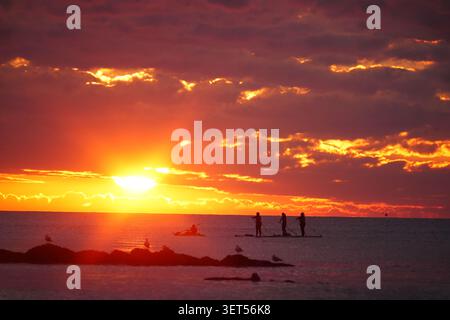 People gather at Cullercoats Bay, North Tyneside during sunrise on the ...