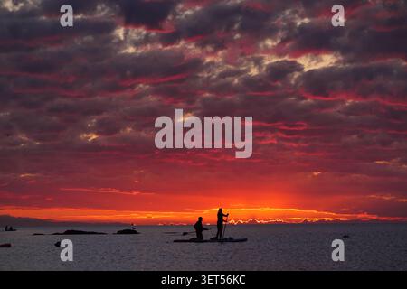 People gather at Cullercoats Bay, North Tyneside during sunrise on the ...