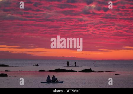 People gather at Cullercoats Bay, North Tyneside during sunrise on the ...