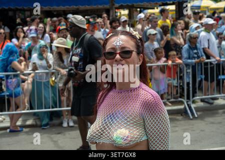 A reveler with their face painted participates in the annual Mermaid ...