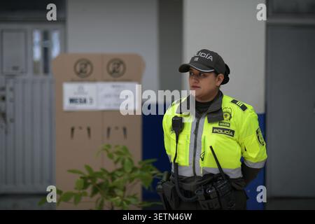 Colombian police guard the electoral process during the runoff election ...