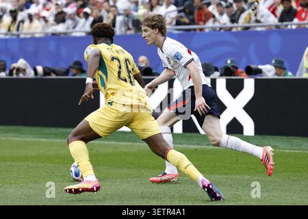Anthony Gordon (England) and Marvin Senaya (Ghana) battle for the ball ...